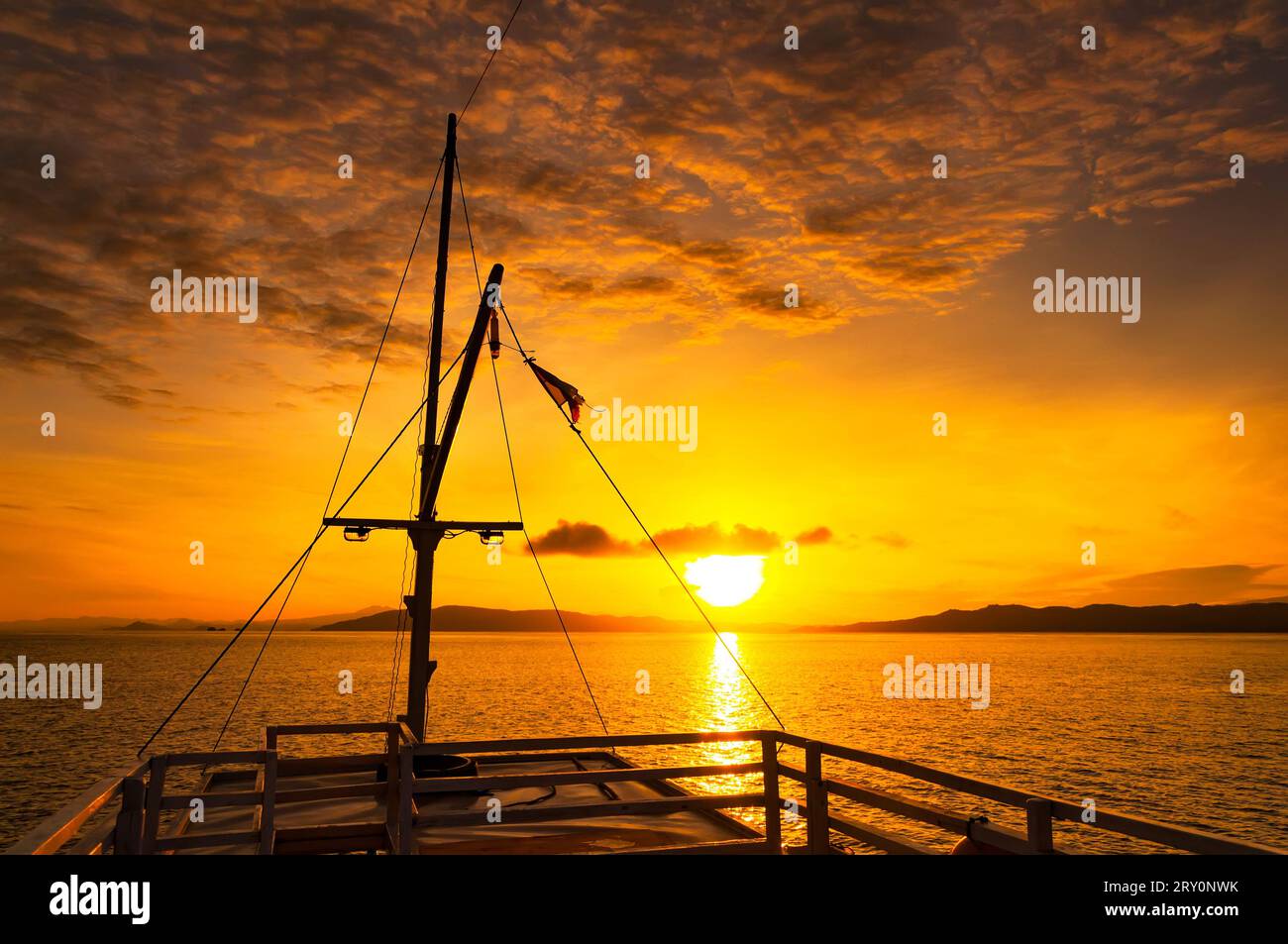 Wooden mast yacht floating in the sea at sunset Stock Photo - Alamy