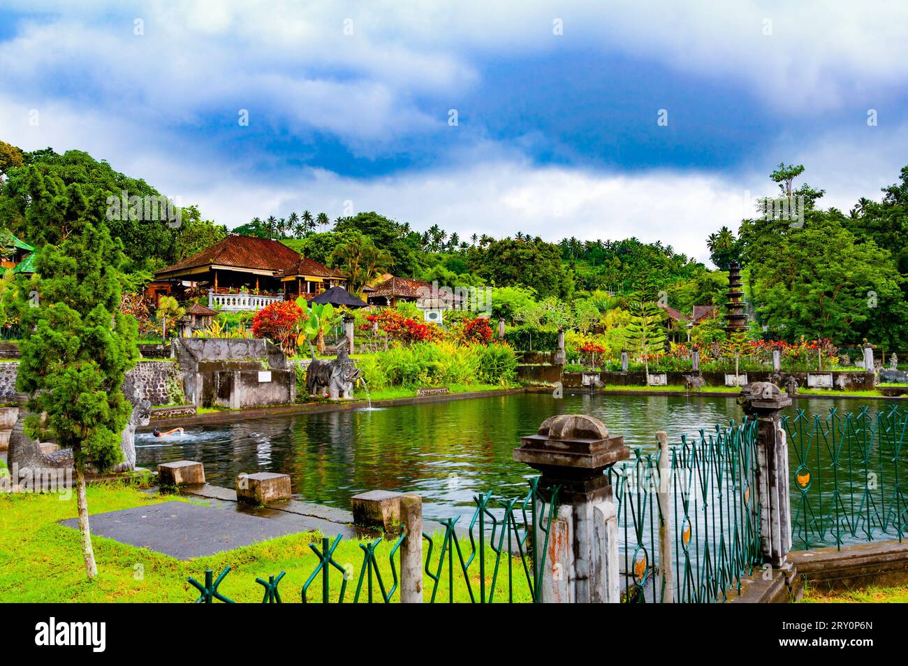 Pergolas, pond and fountain in the water palace Tirta Gangga. Bali ...
