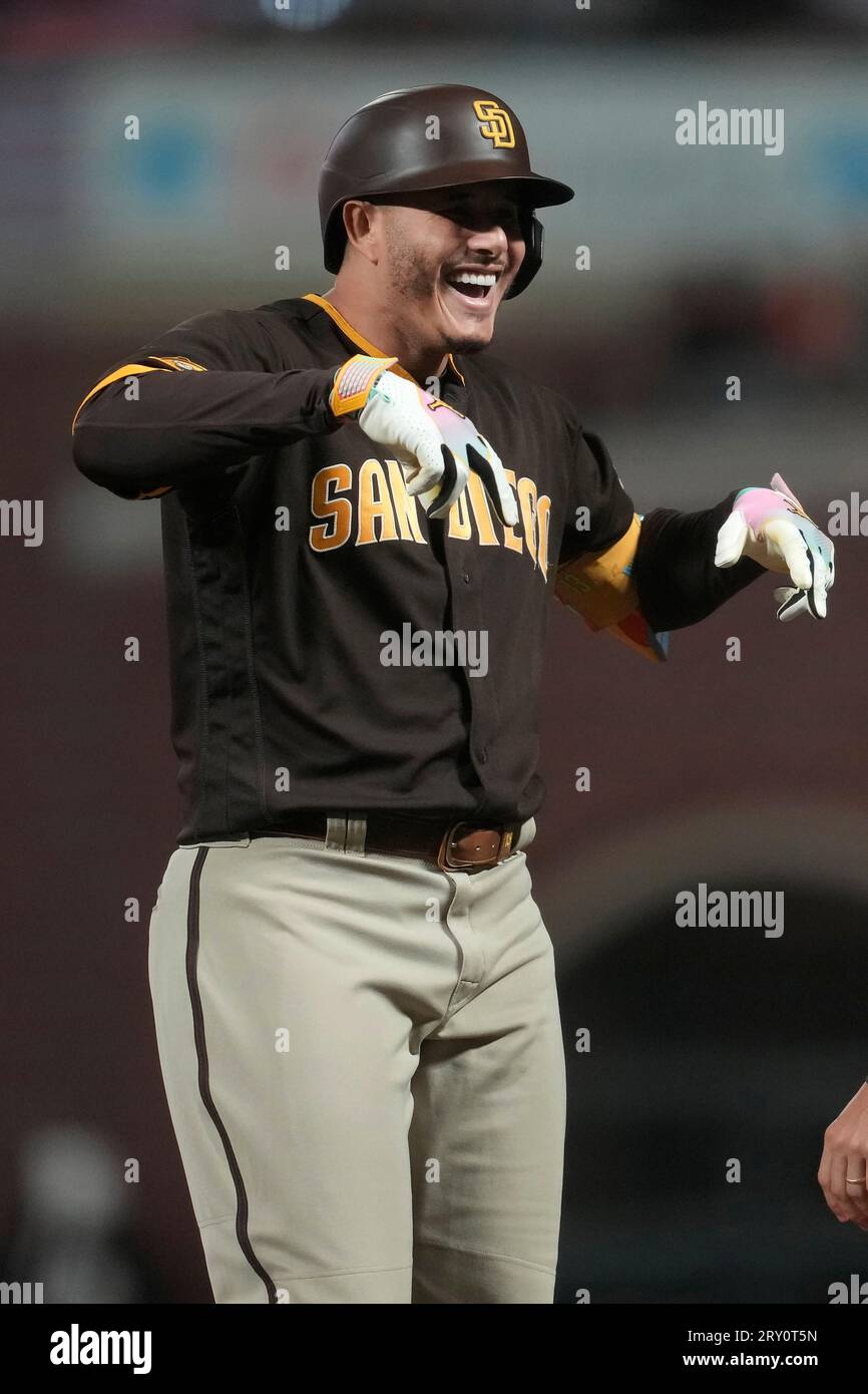 San Diego Padres' Manny Machado gestures toward teammates after hitting ...