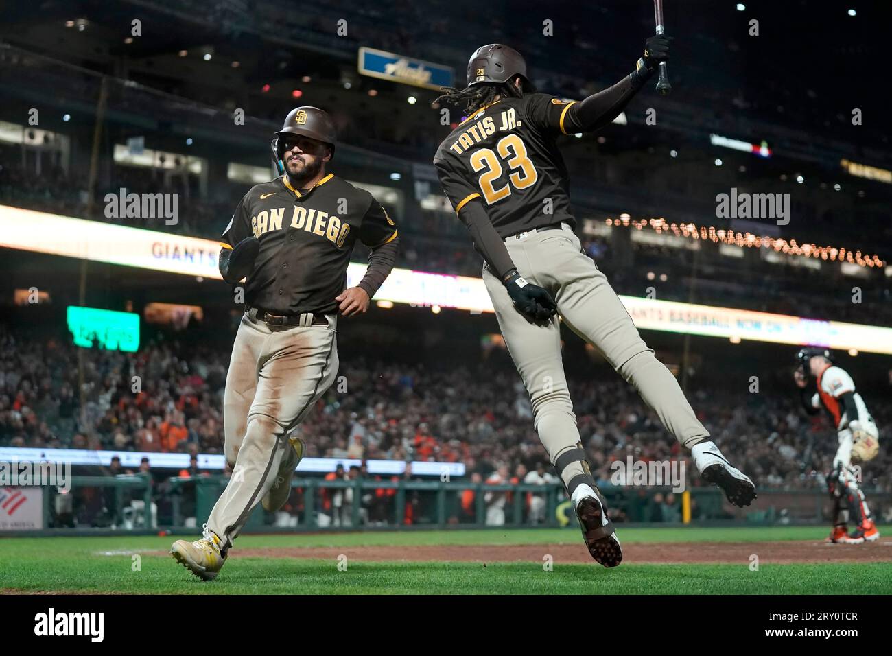 San Diego Padres' Trent Grisham, left, runs toward Fernando Tatis Jr ...
