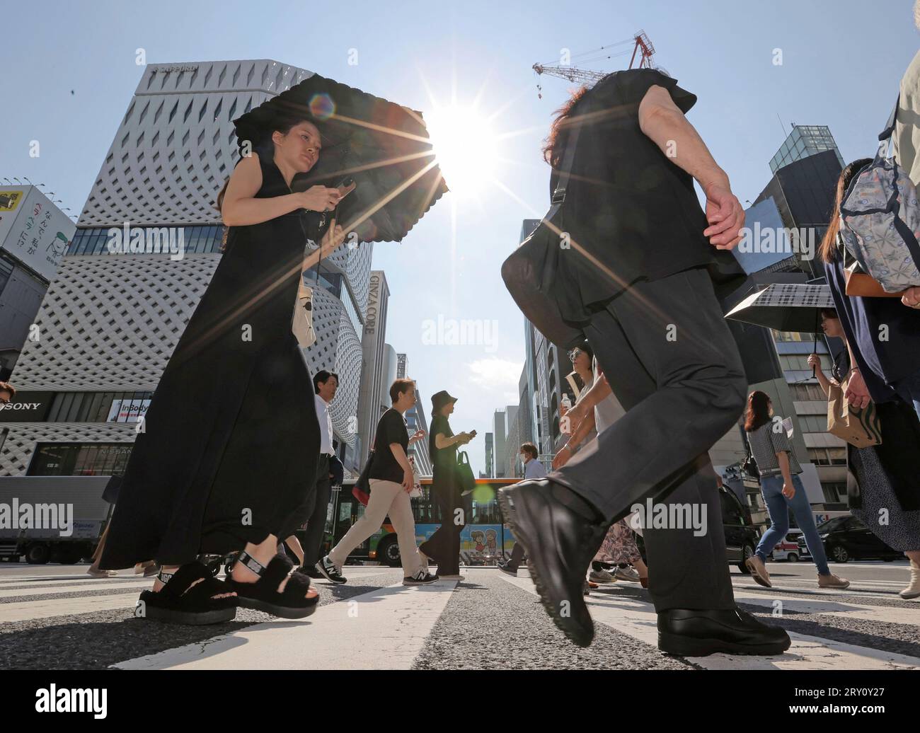 People walk while sweltering hot at Ginza district in Tokyo on ...
