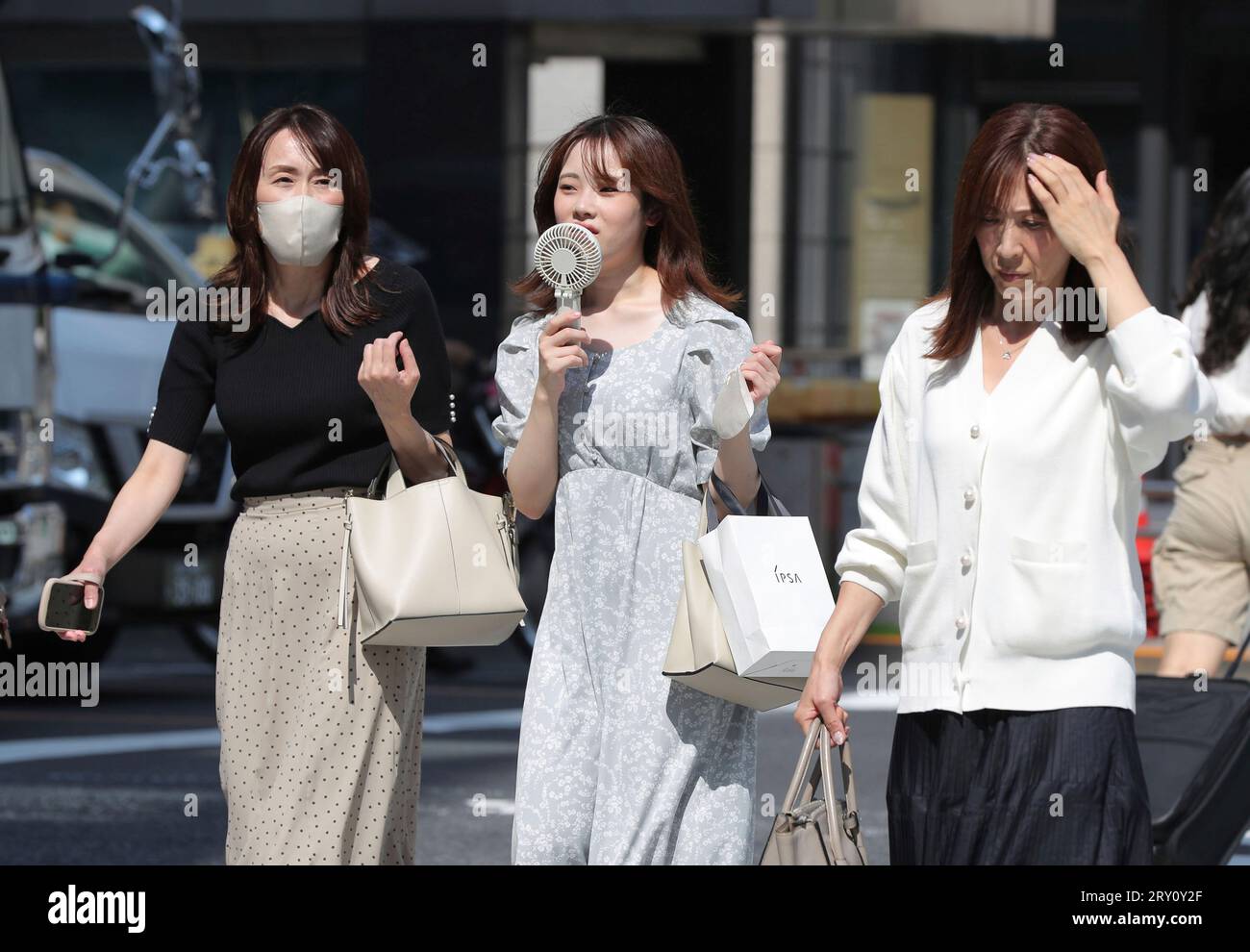 People walk while sweltering hot at Ginza district in Tokyo on ...