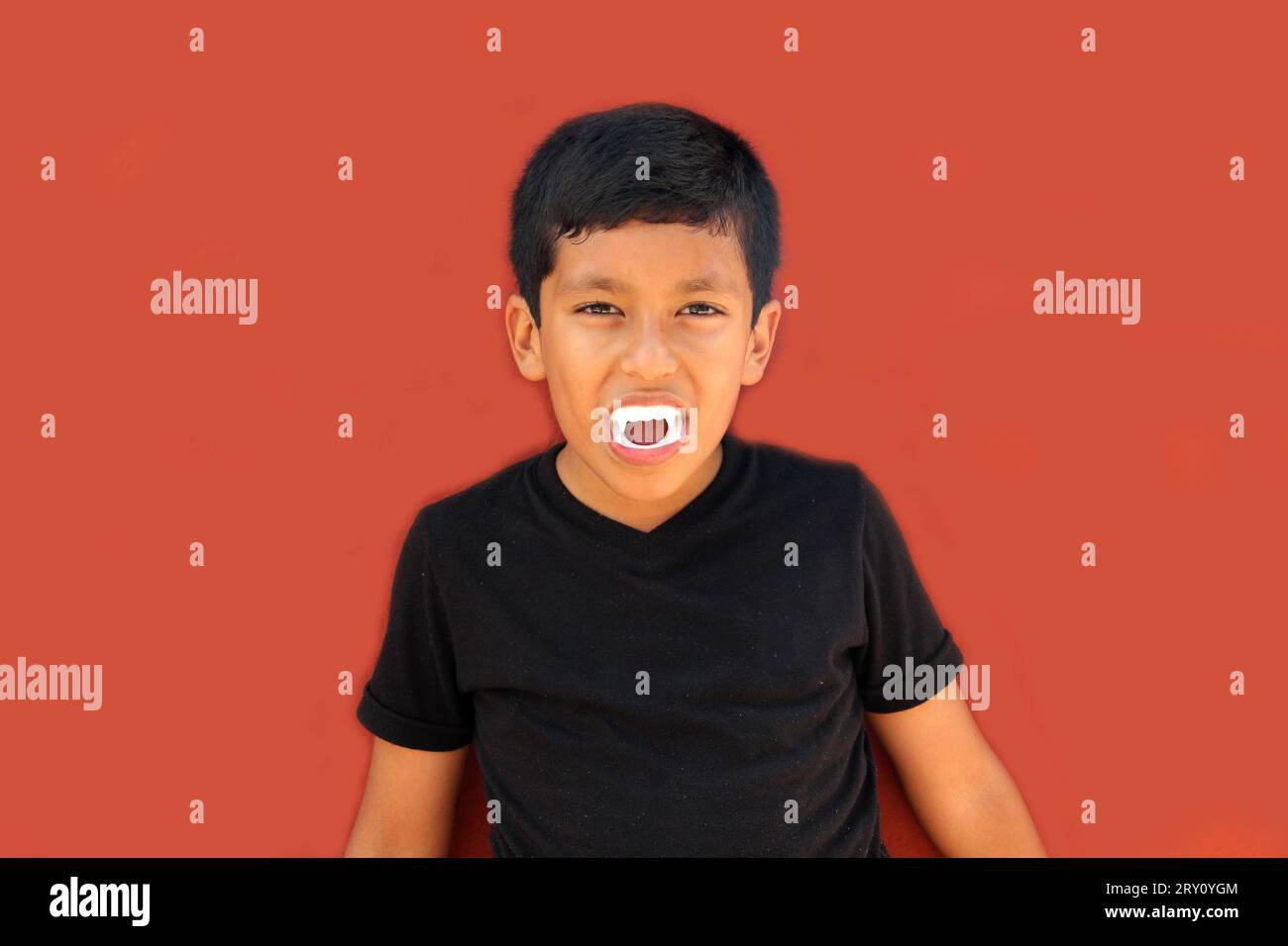 9-year-old dark-skinned Latino boy wearing vampire costume teeth to ...