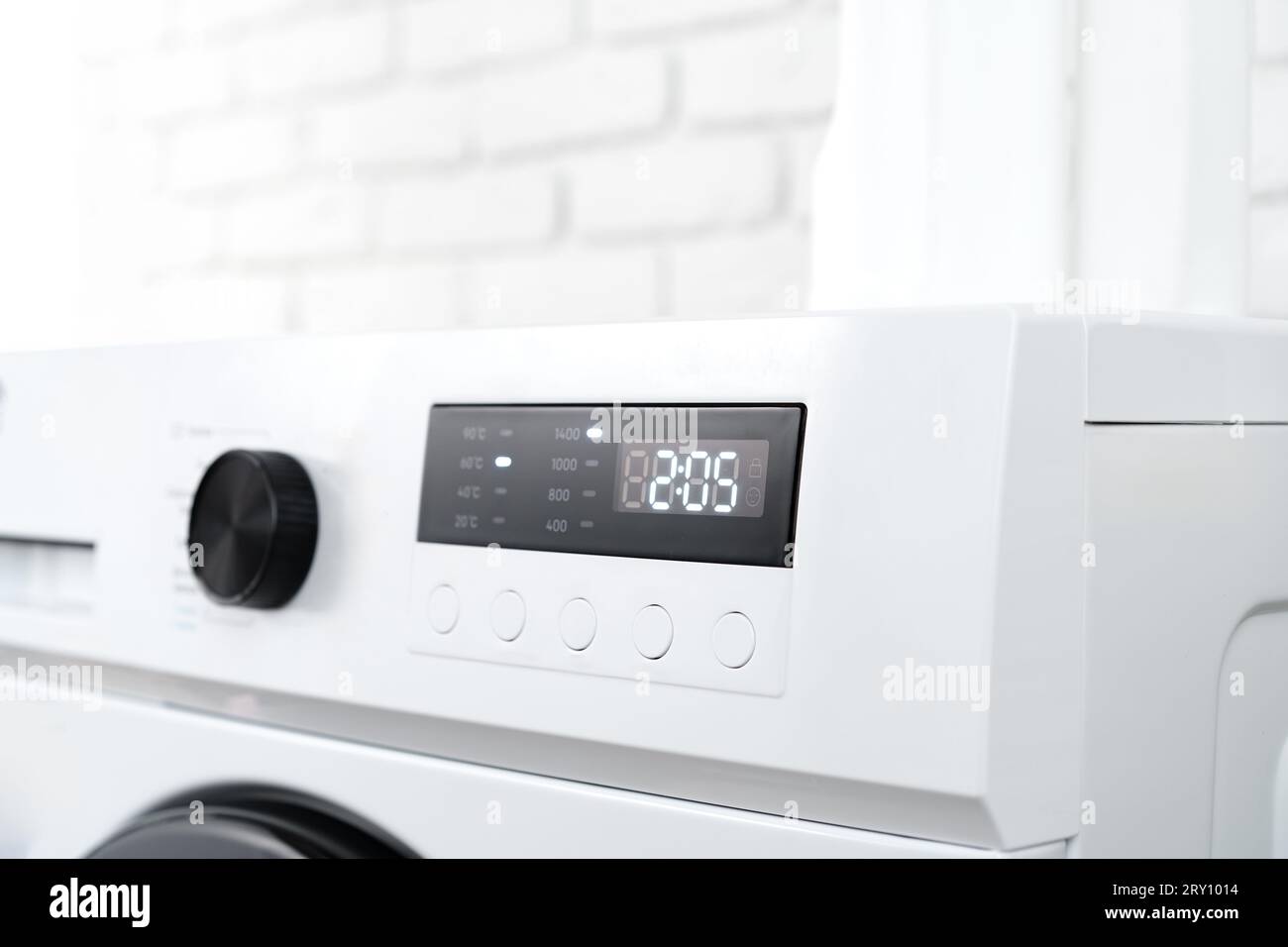 Modern white washing machine in a laundry room Stock Photo - Alamy