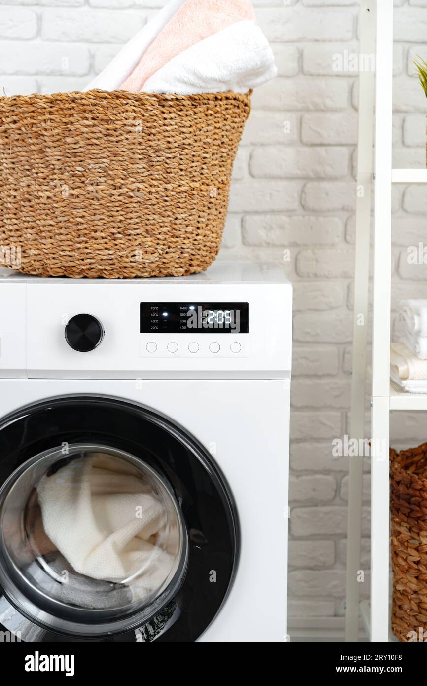 Laundry basket on washing machine in a laundry room Stock Photo - Alamy