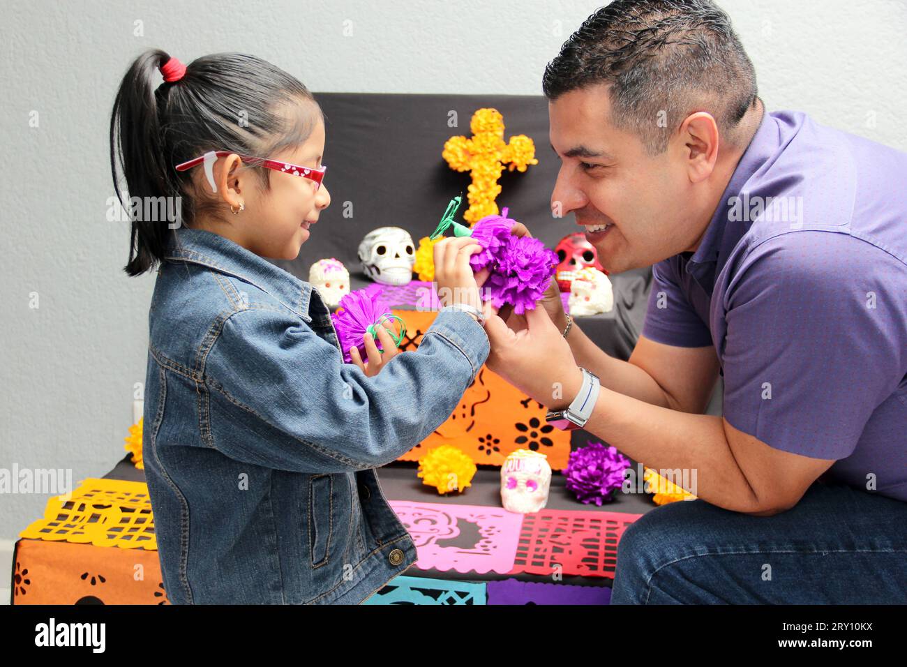 Mexican dad and daughter put the altar and offering of the Day of the ...