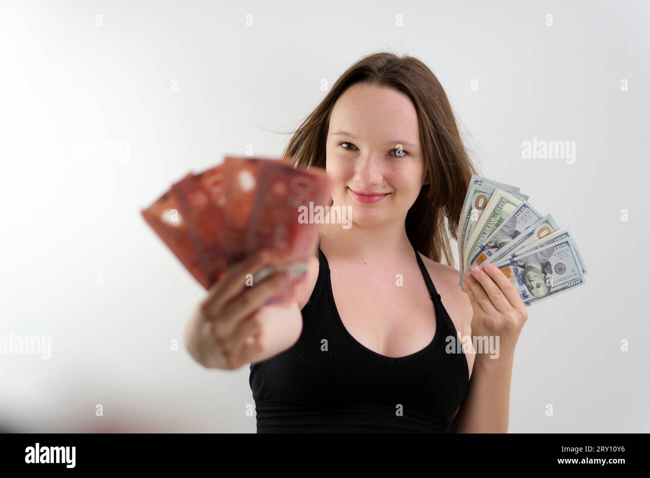 canadian dollars Beautiful girl holding dollars in hands. Isolated on ...