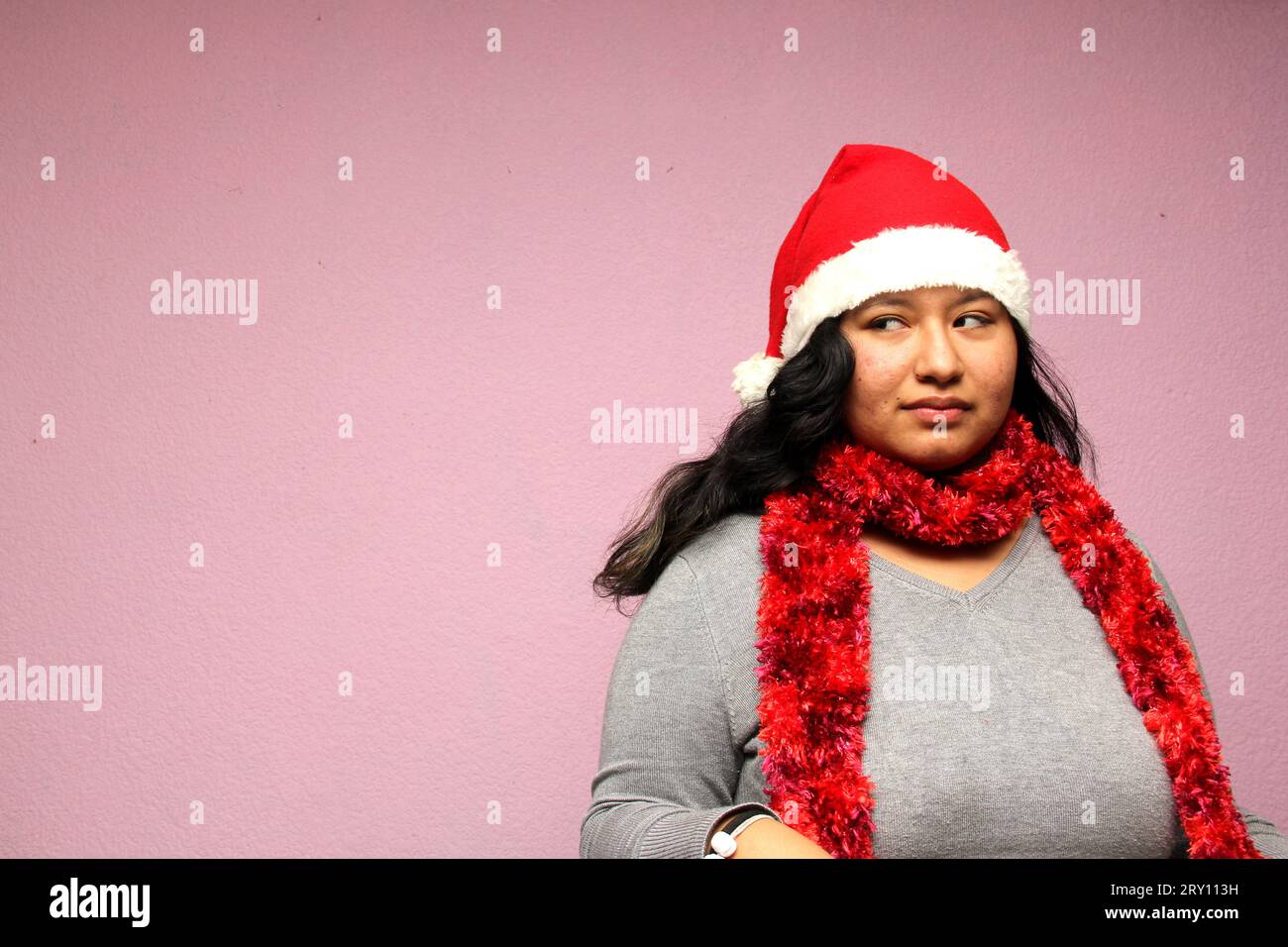 Young fat overweight body positive Latina with Christmas hat shows ...