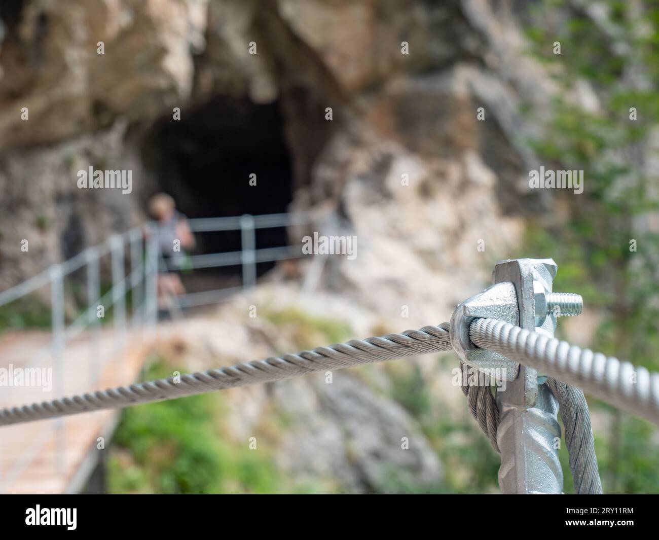 Rope and shackles anchored in hard dolomite limestone rock. Climbers ...