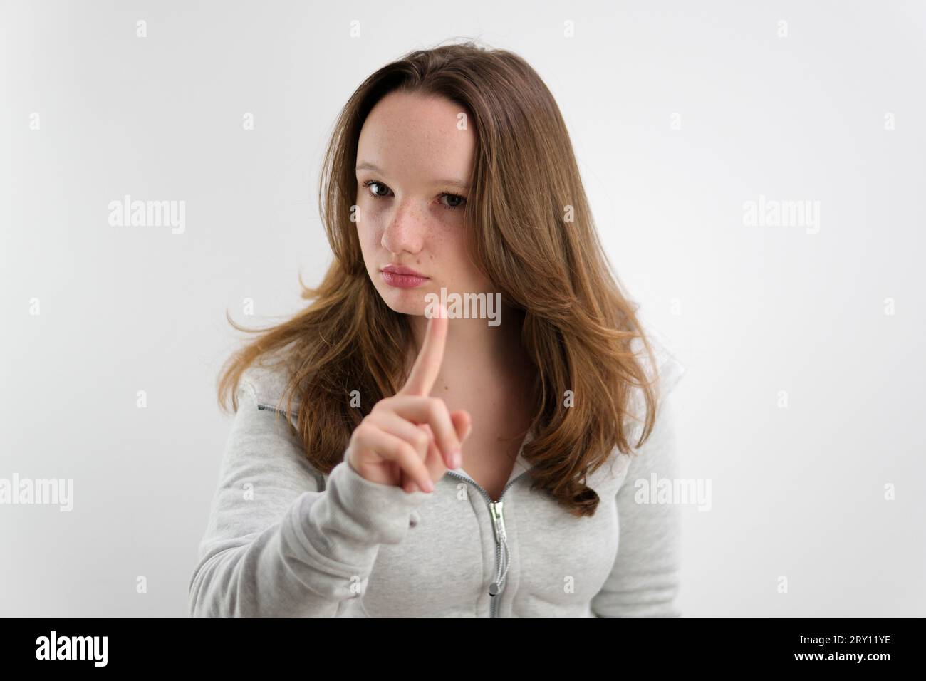 young beautiful girl teenager raised her index finger up alert think be ...