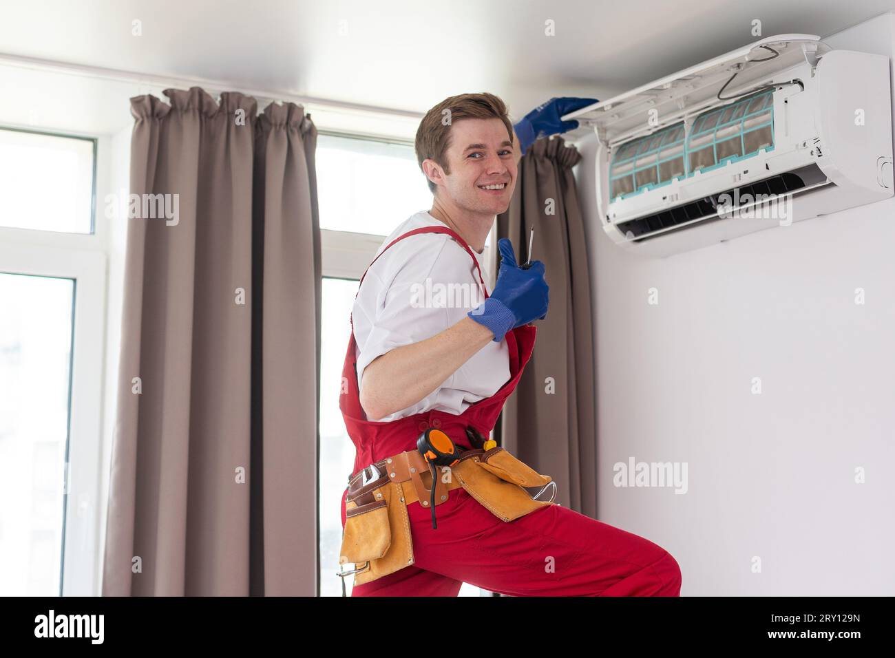 the worker connecting a new air conditioner unit Stock Photo - Alamy