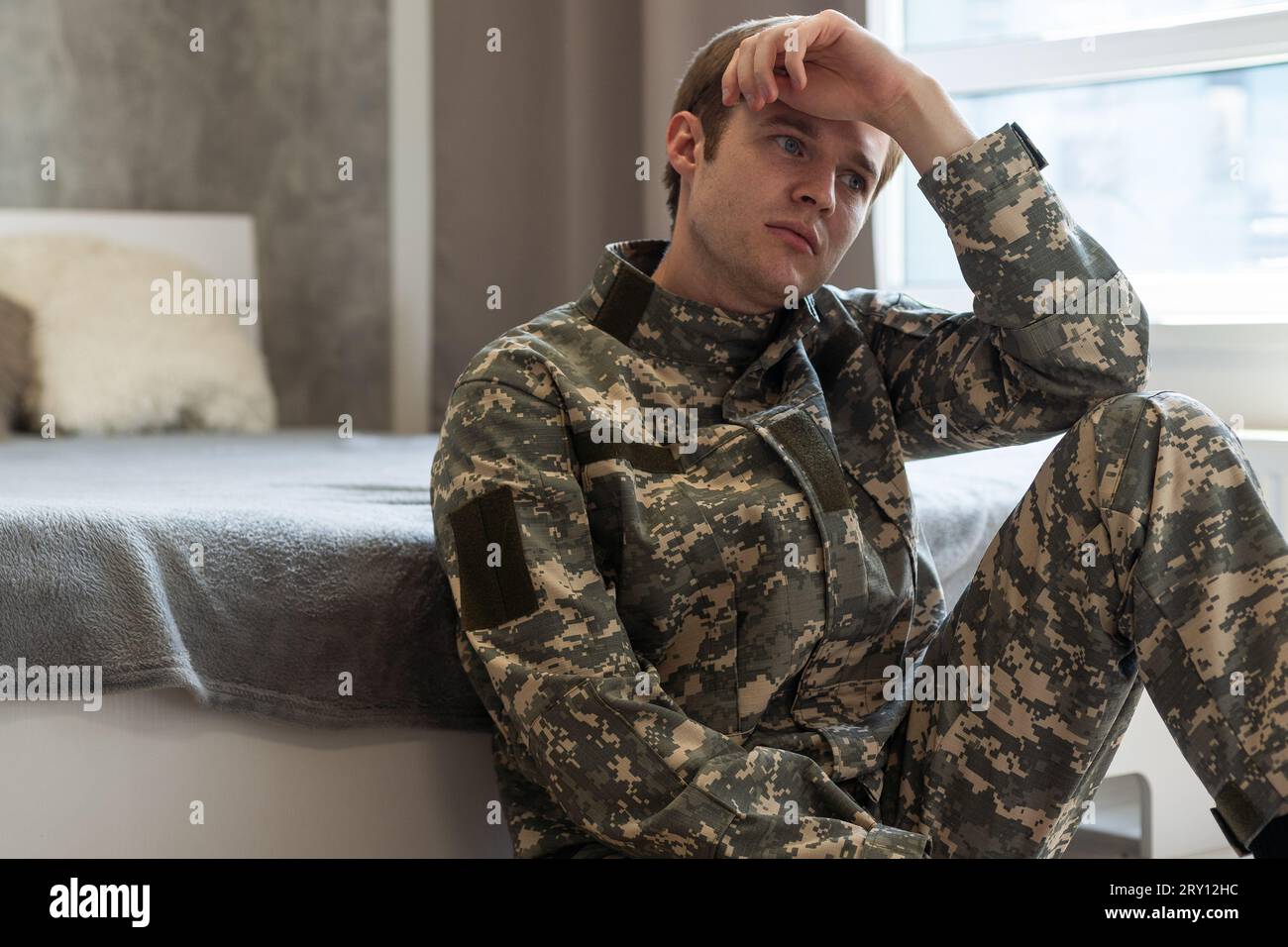 Stressed veteran soldier engrossed in depressive thoughts and memories ...