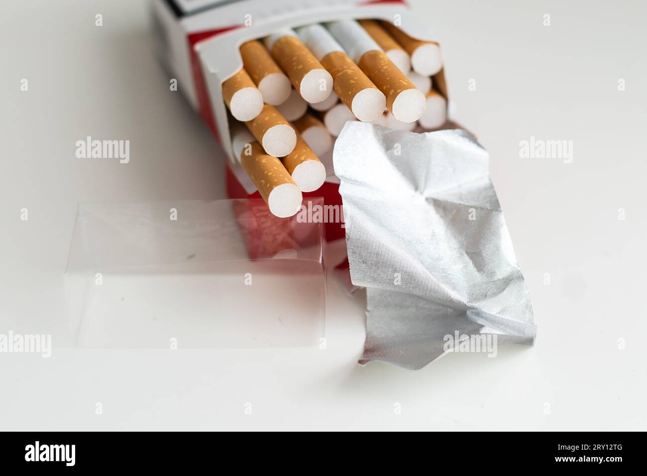 Cigarettes in the cigarette box over white background Stock Photo - Alamy
