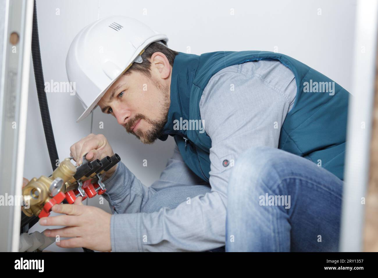 professional plumber checking water valves Stock Photo - Alamy