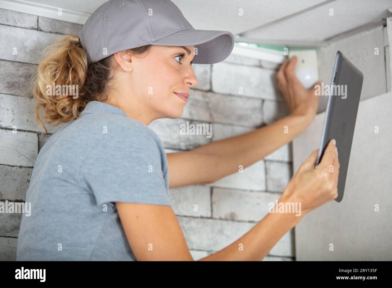 a woman is a cctv installer Stock Photo - Alamy