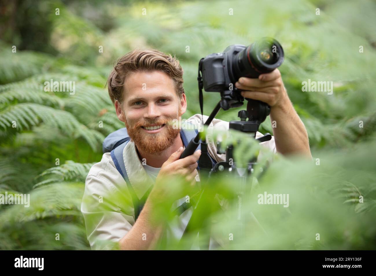 man filming holding camera stabilizer Stock Photo - Alamy