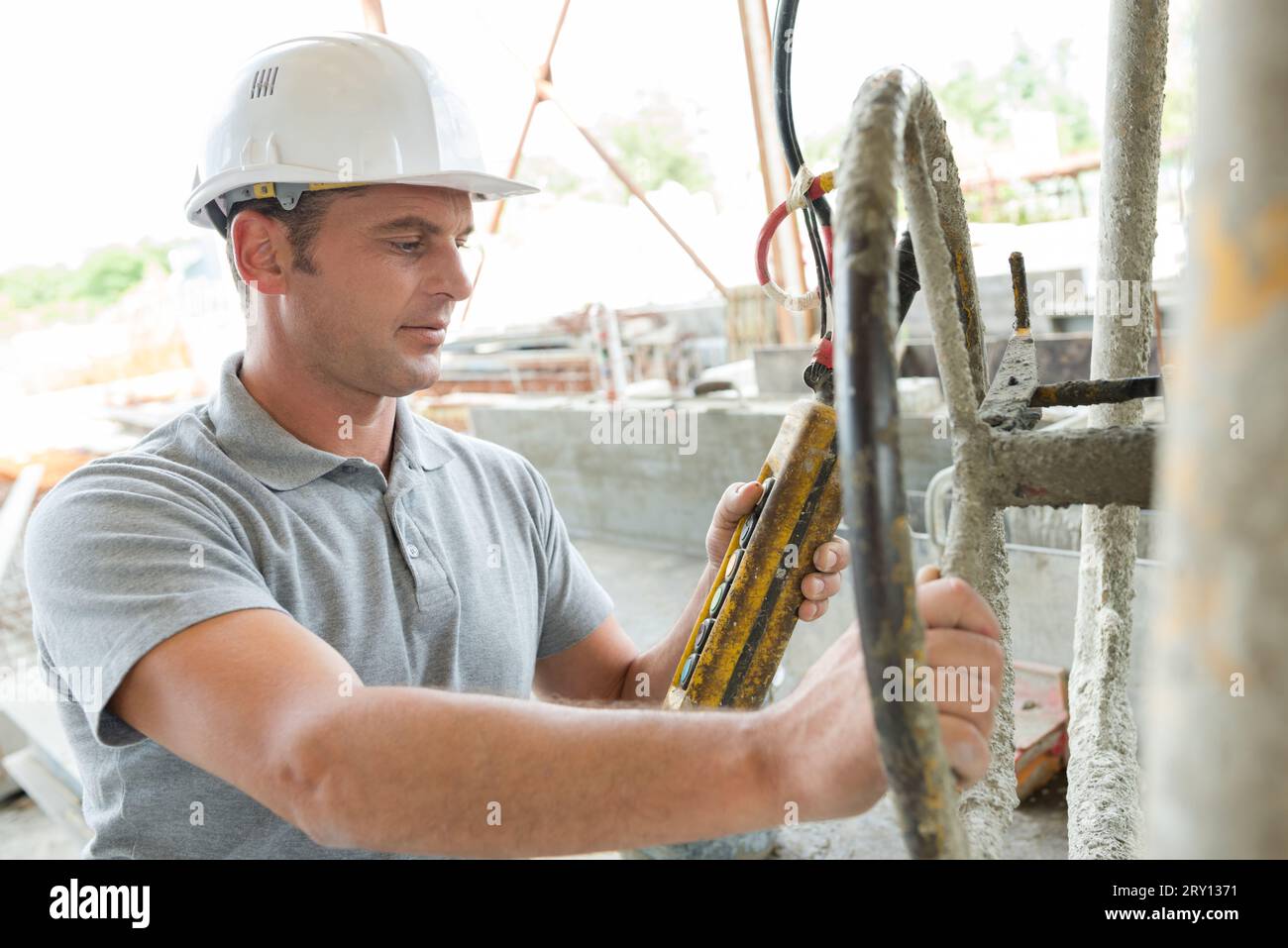 builder turning wheel and operating machinery controls Stock Photo - Alamy