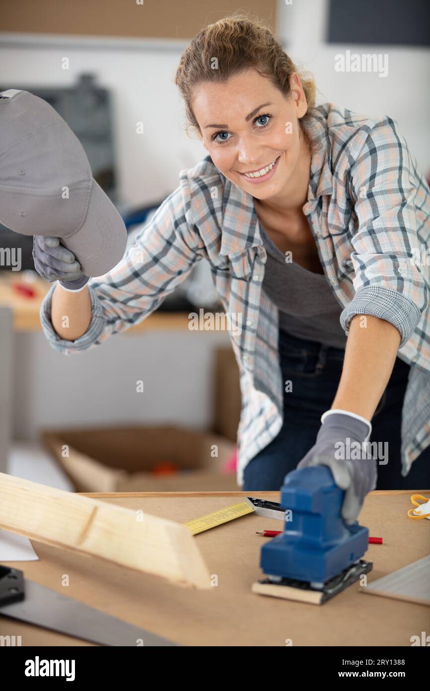 female carpenter using electric sander for wood Stock Photo - Alamy