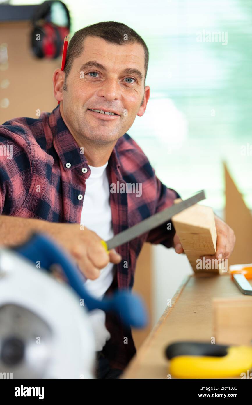 carpenter at work polishing wood using sander Stock Photo - Alamy