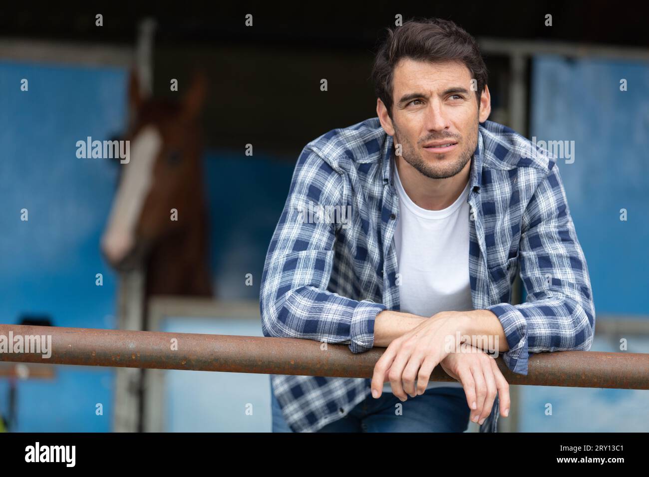 contemplative man at riding stables Stock Photo - Alamy