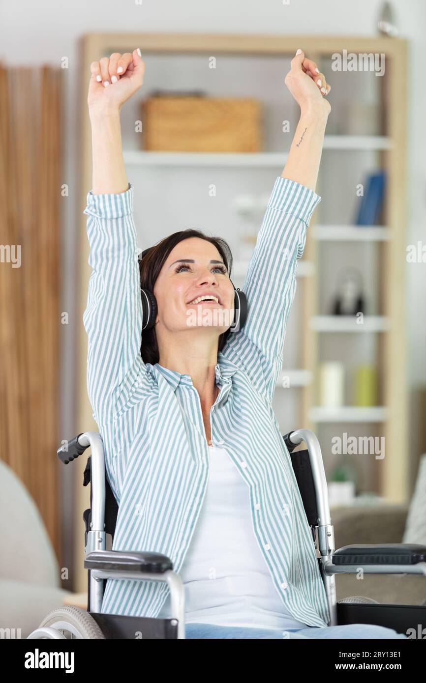 young disabled woman in wheelchair at home in living room Stock Photo ...