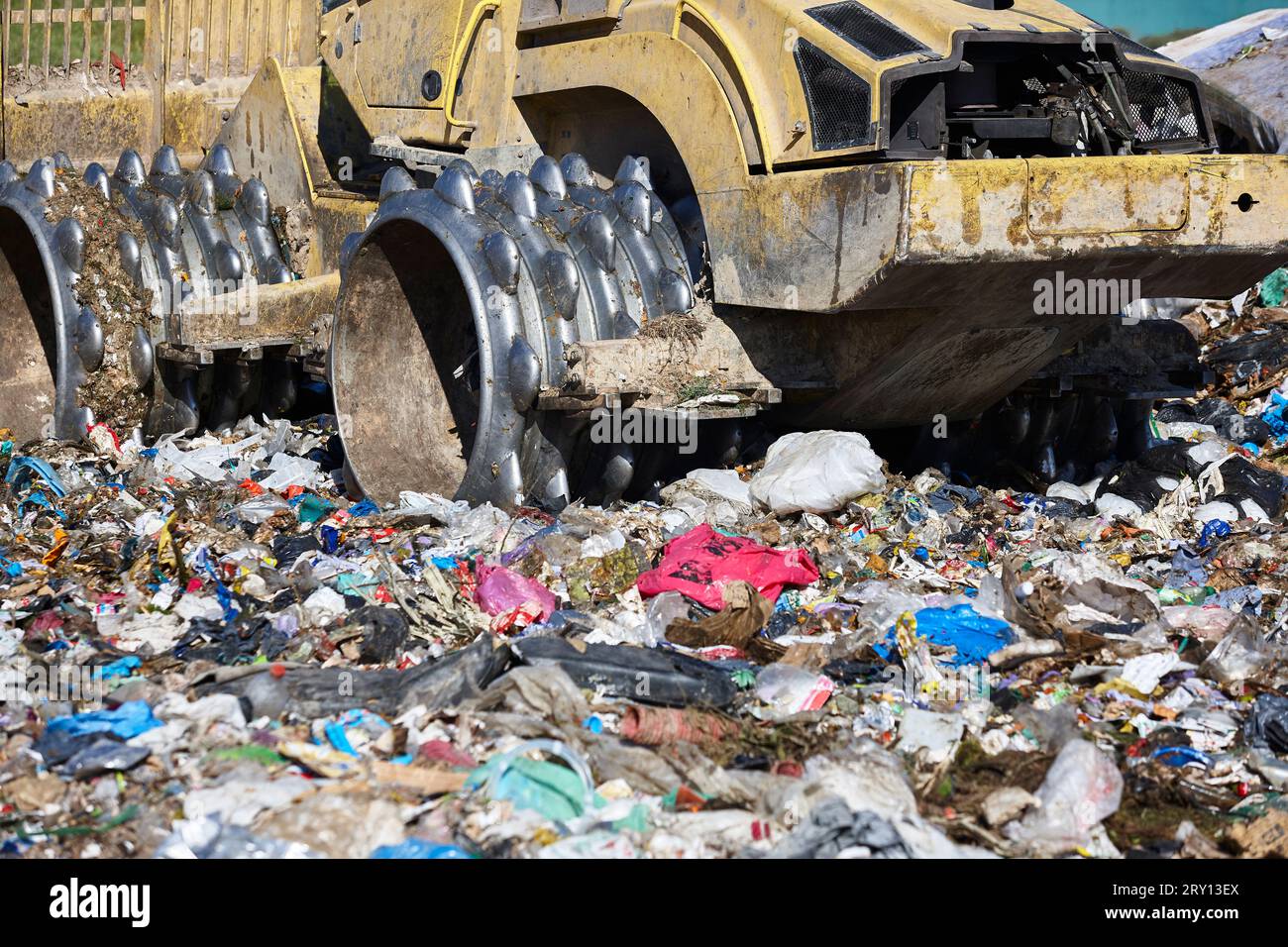 Heavy machinery shredding garbage in an open air landfill. Waste Stock ...