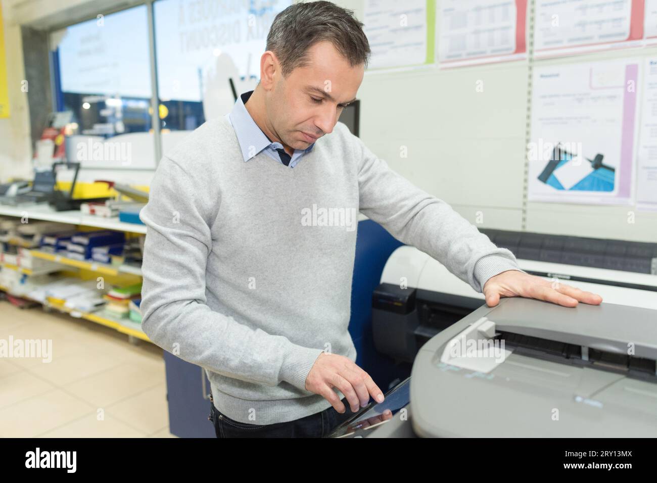man copying paper from photocopier sunlight from window Stock Photo - Alamy