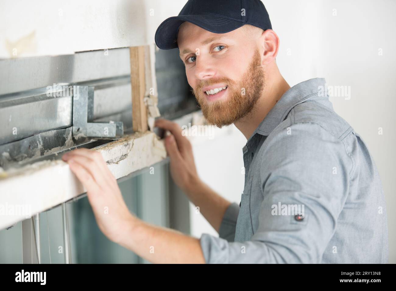 handsome young man installing a window Stock Photo - Alamy