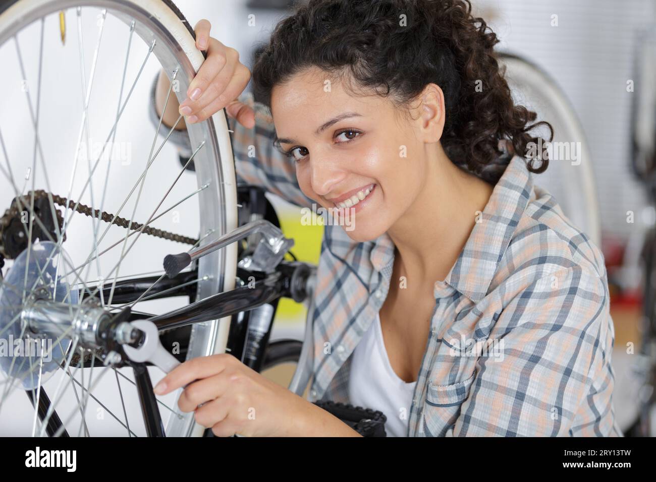 Girl fixing bike hi-res stock photography and images - Alamy