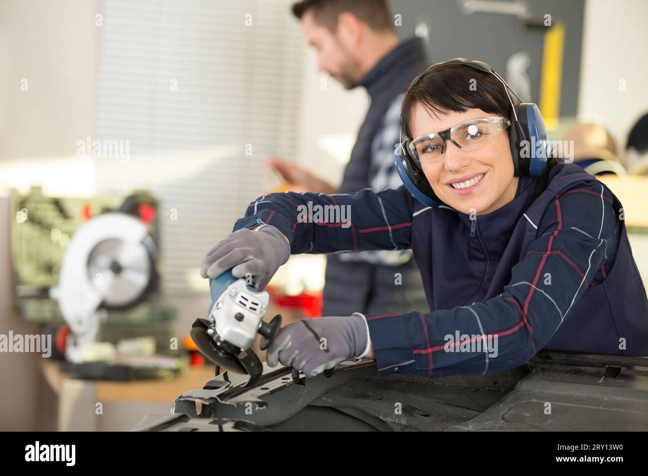 happy female worker cutting metal at industrial plant Stock Photo - Alamy
