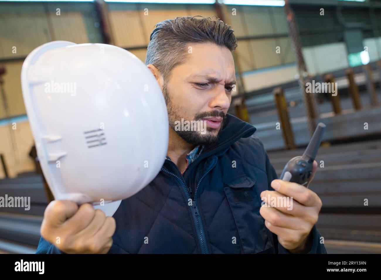 manual worker using walkie-talkie in metal industry Stock Photo - Alamy