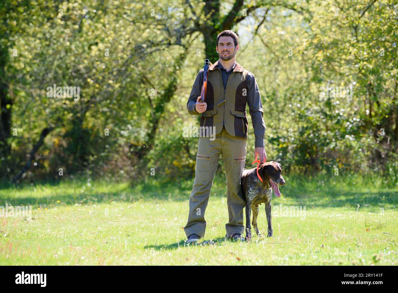 hunter with dog in forest Stock Photo - Alamy