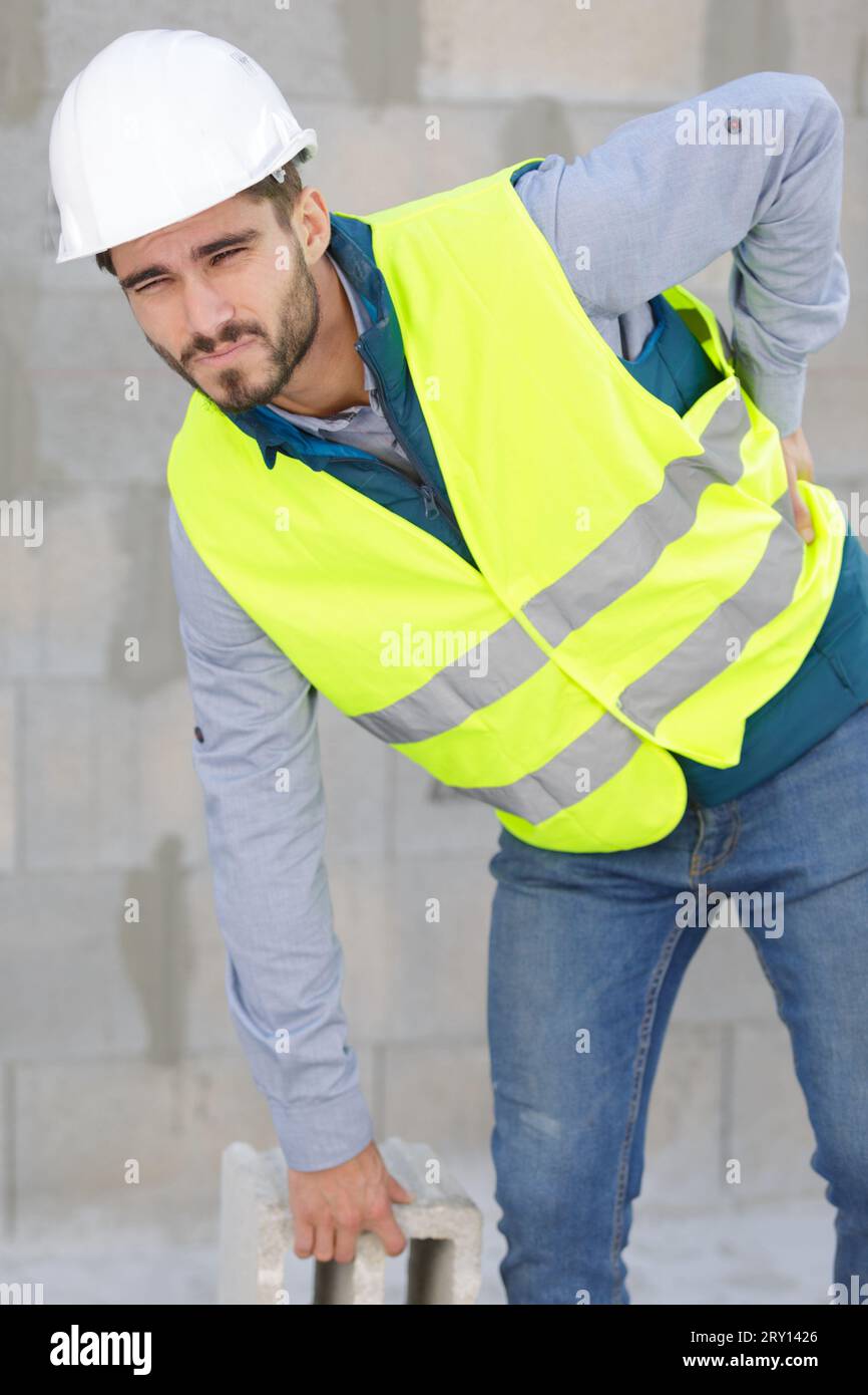 construction worker experiencing back pain Stock Photo - Alamy