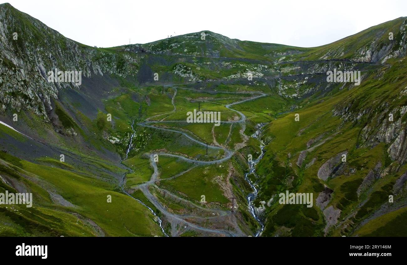 Aerial scenic view of Caucasus mountains peak with green rocky valley ...