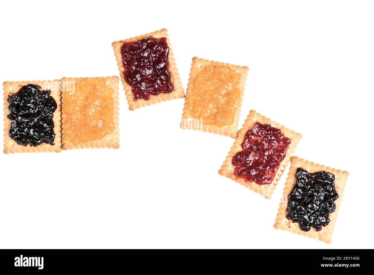 Some dry biscuits with jam on a white surface Stock Photo - Alamy