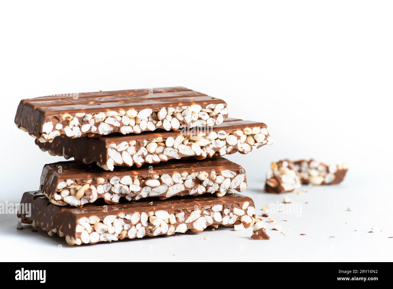 Chunks of milk chocolate with puffed rice isolated on white background ...