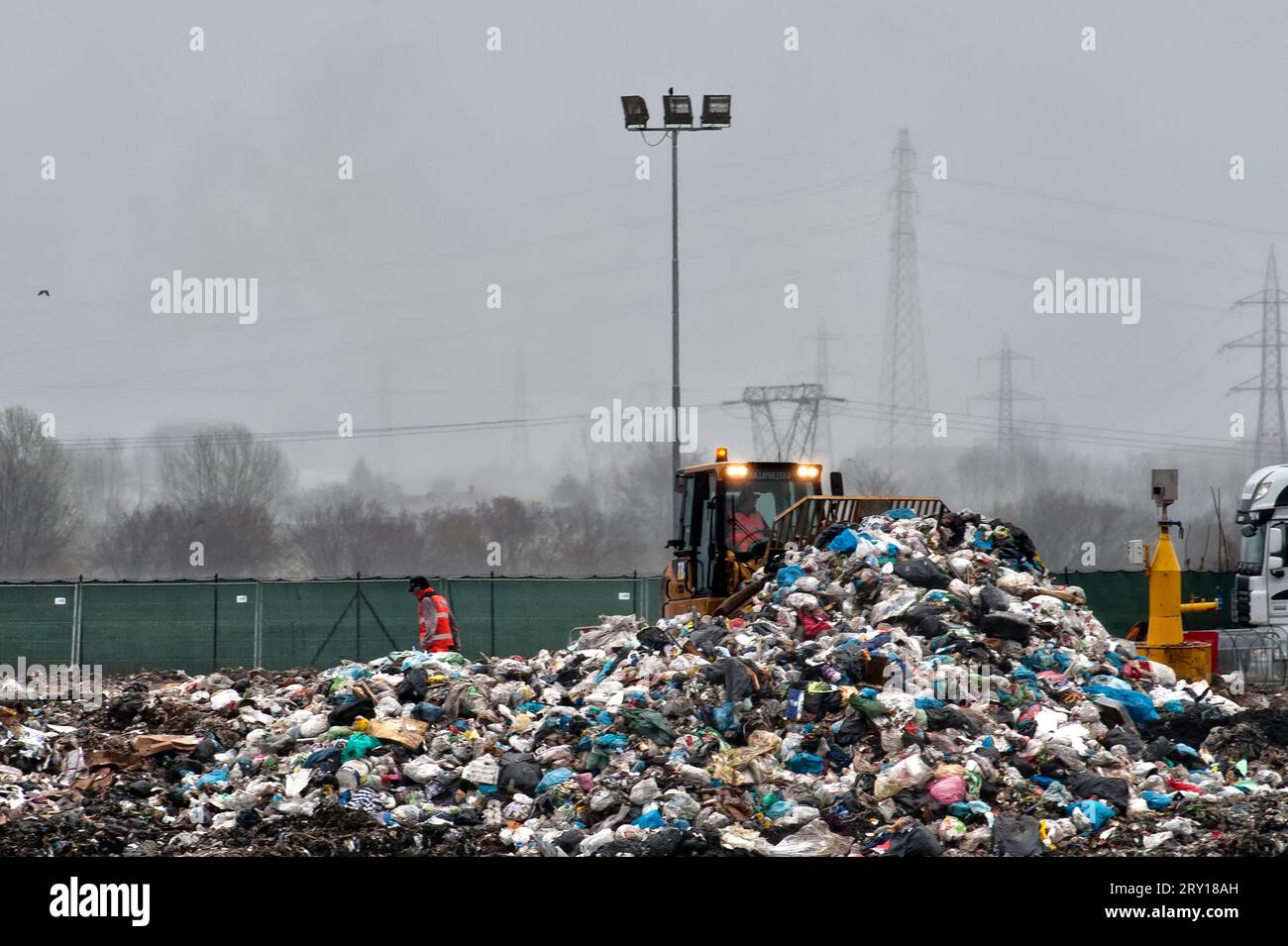 Dump municipal waste. Workers with trucks and bulldozers at work in ...