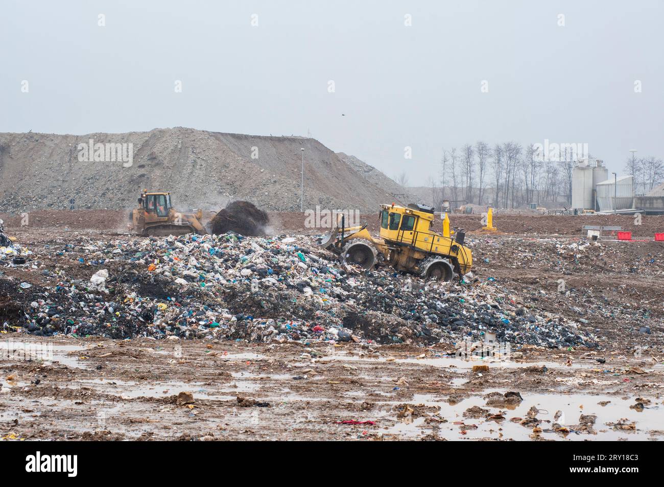 Dump municipal waste. Workers with trucks and bulldozers at work in ...