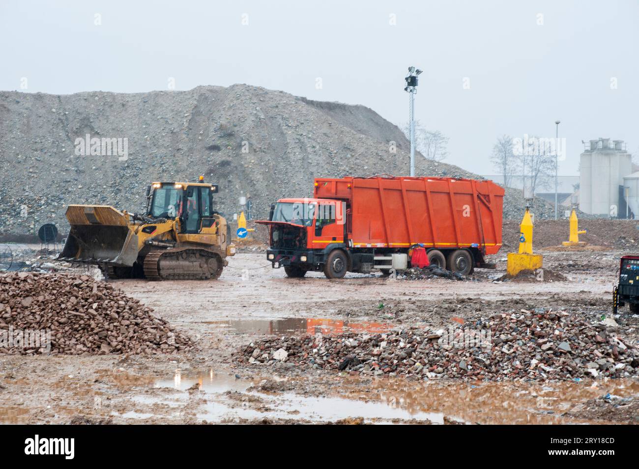 Dump municipal waste. Workers with trucks and bulldozers at work in ...