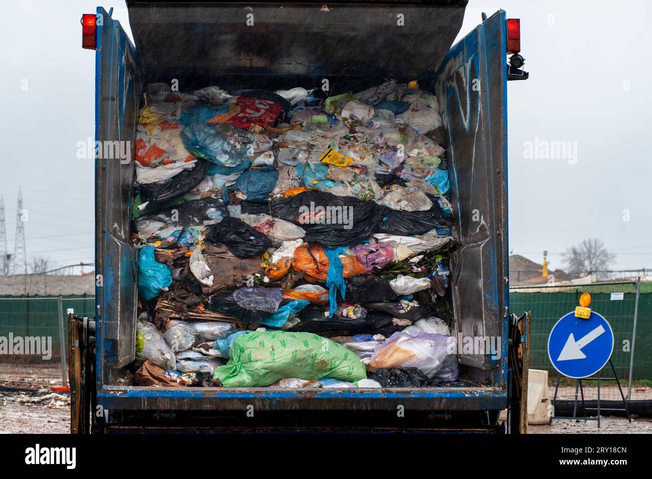 Dump municipal waste. Workers with trucks and bulldozers at work in ...