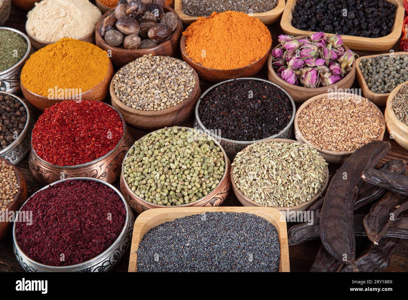 Colorful background with various herbs and spices for cooking in bowls ...