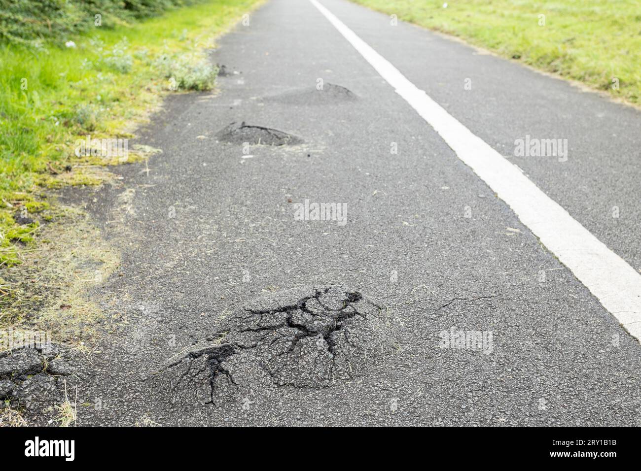 Dangerous road, path with holes destroyed Stock Photo - Alamy