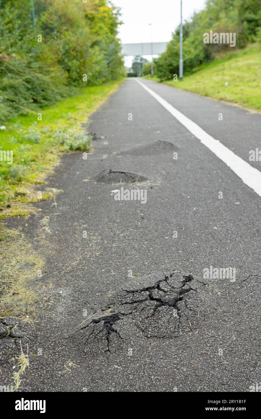 Dangerous road, path with holes destroyed Stock Photo - Alamy