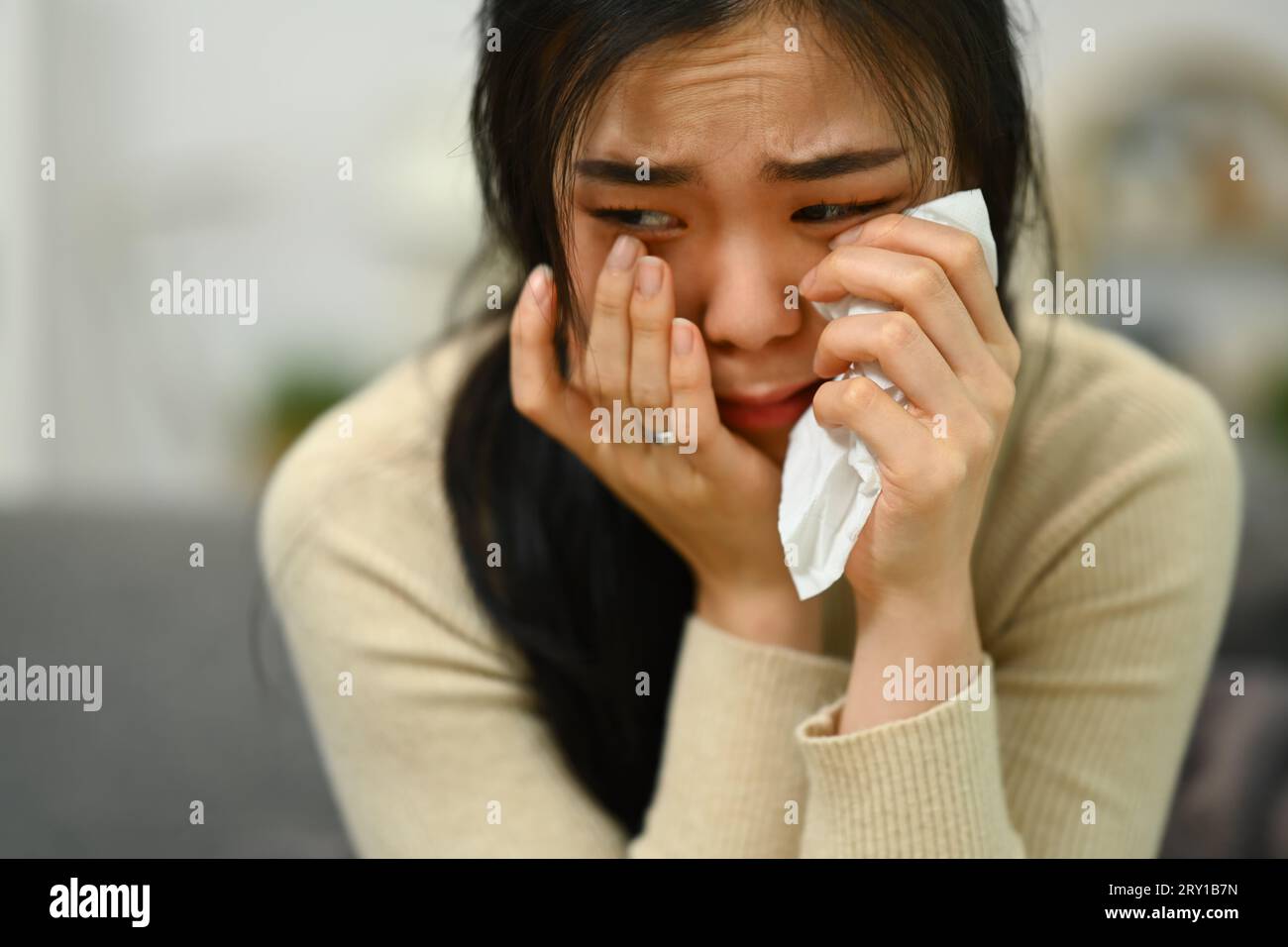 Frustrated unhappy young woman crying on sofa couch at home feeling ...