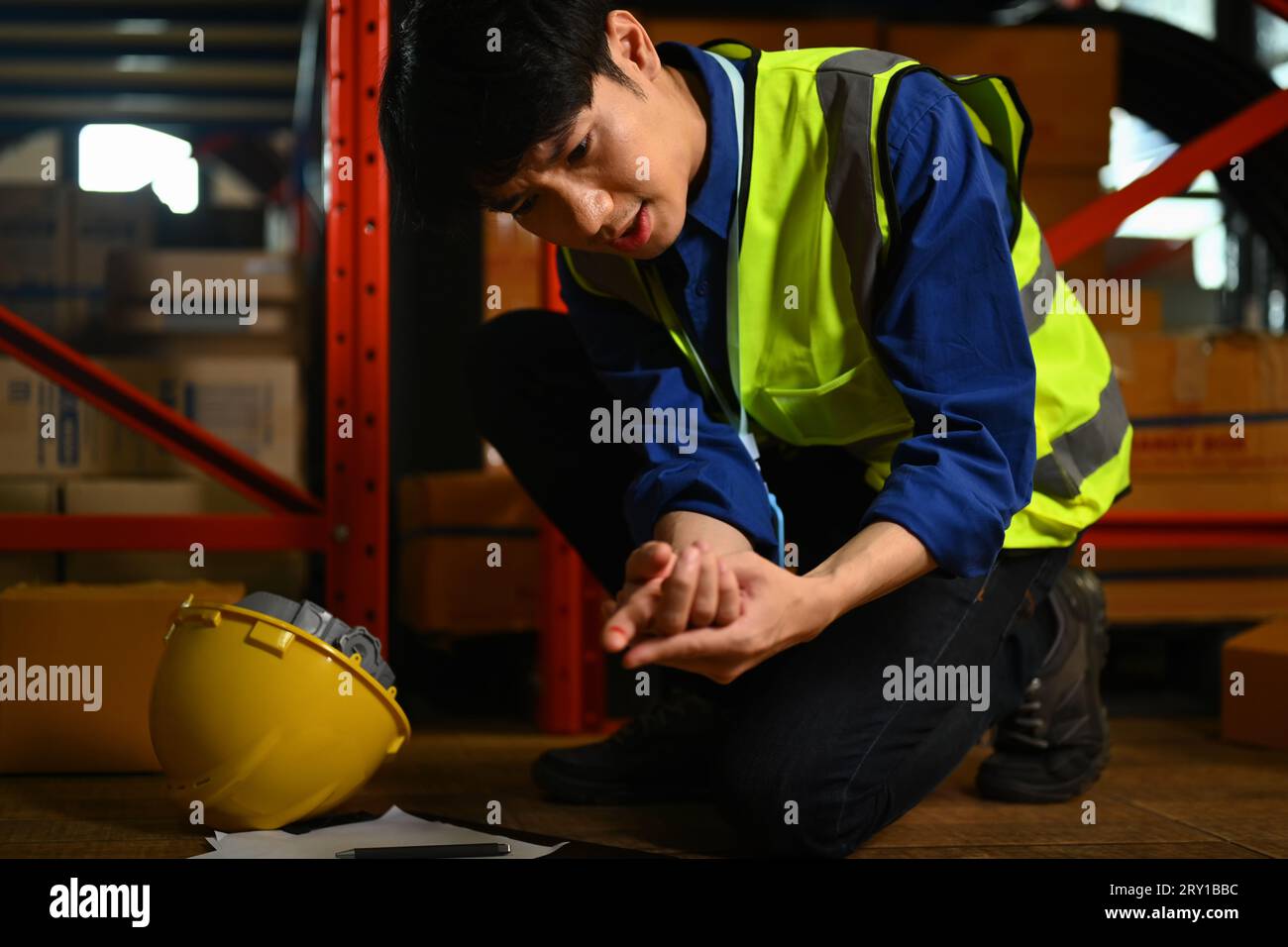 Male worker with bleeding blood from the cut finger wound. Industrial ...