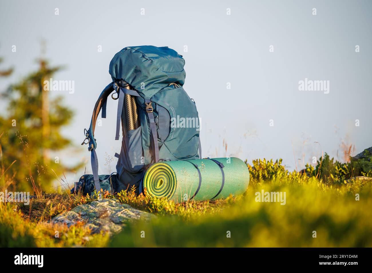 Hiking backpack with mat during trek in mountains. Camping and trekking ...