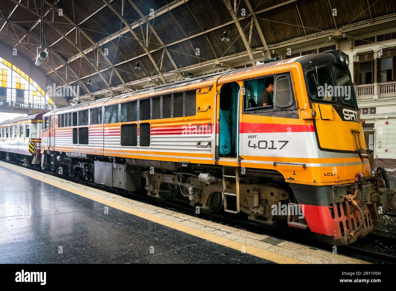 A train engine pulls into the platform with the driver working at Hua ...