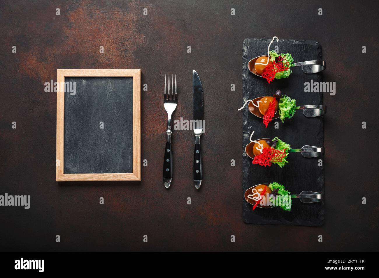 Molecular modern cuisine galantine duck in spoons on stone and rusty ...