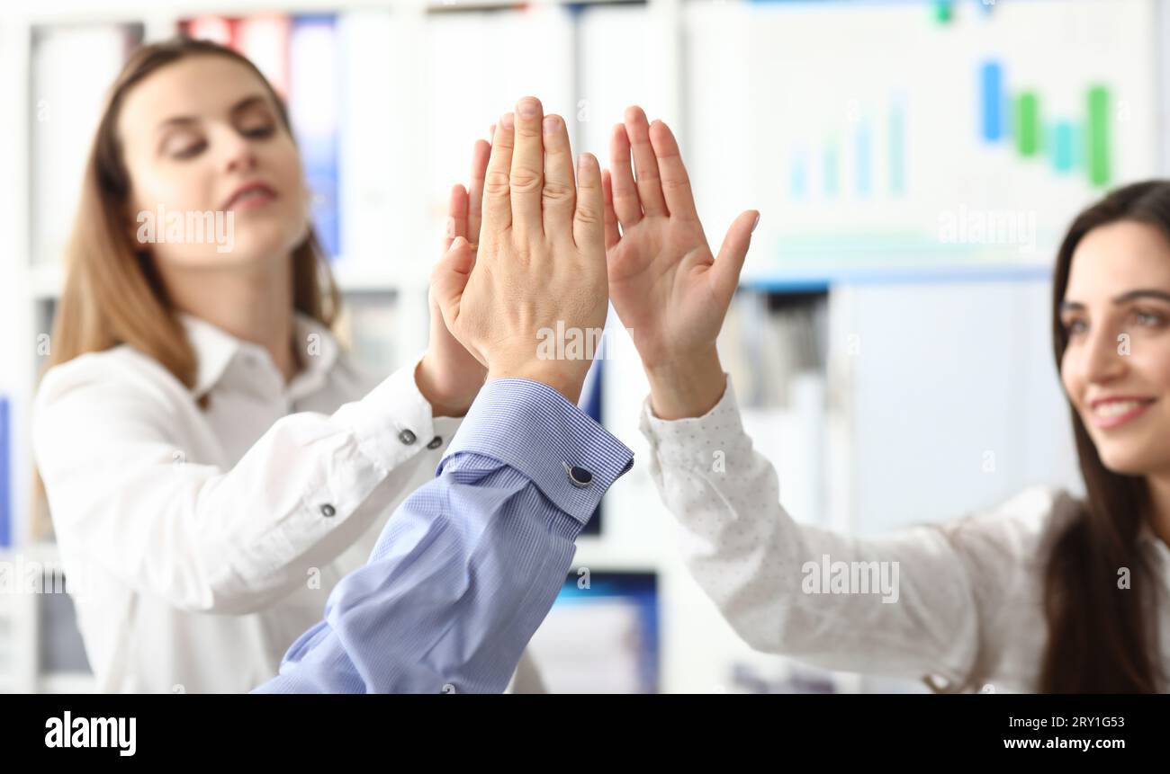 Joyful colleagues high five Stock Photo - Alamy
