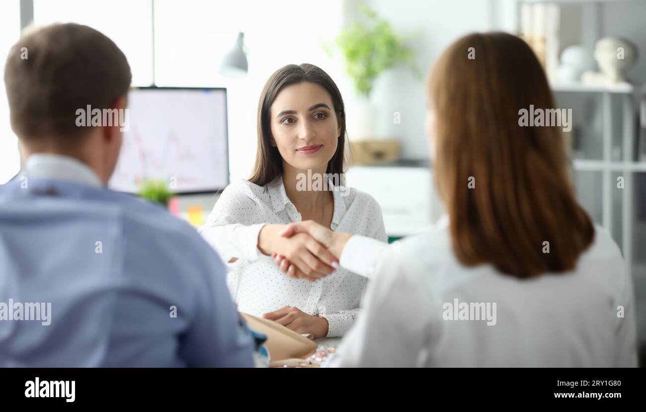 Smart female worker with clients Stock Photo - Alamy
